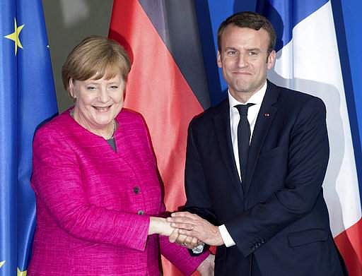 Emmanuel Macron, Angela Merkel say ready to change EU treaties if needed