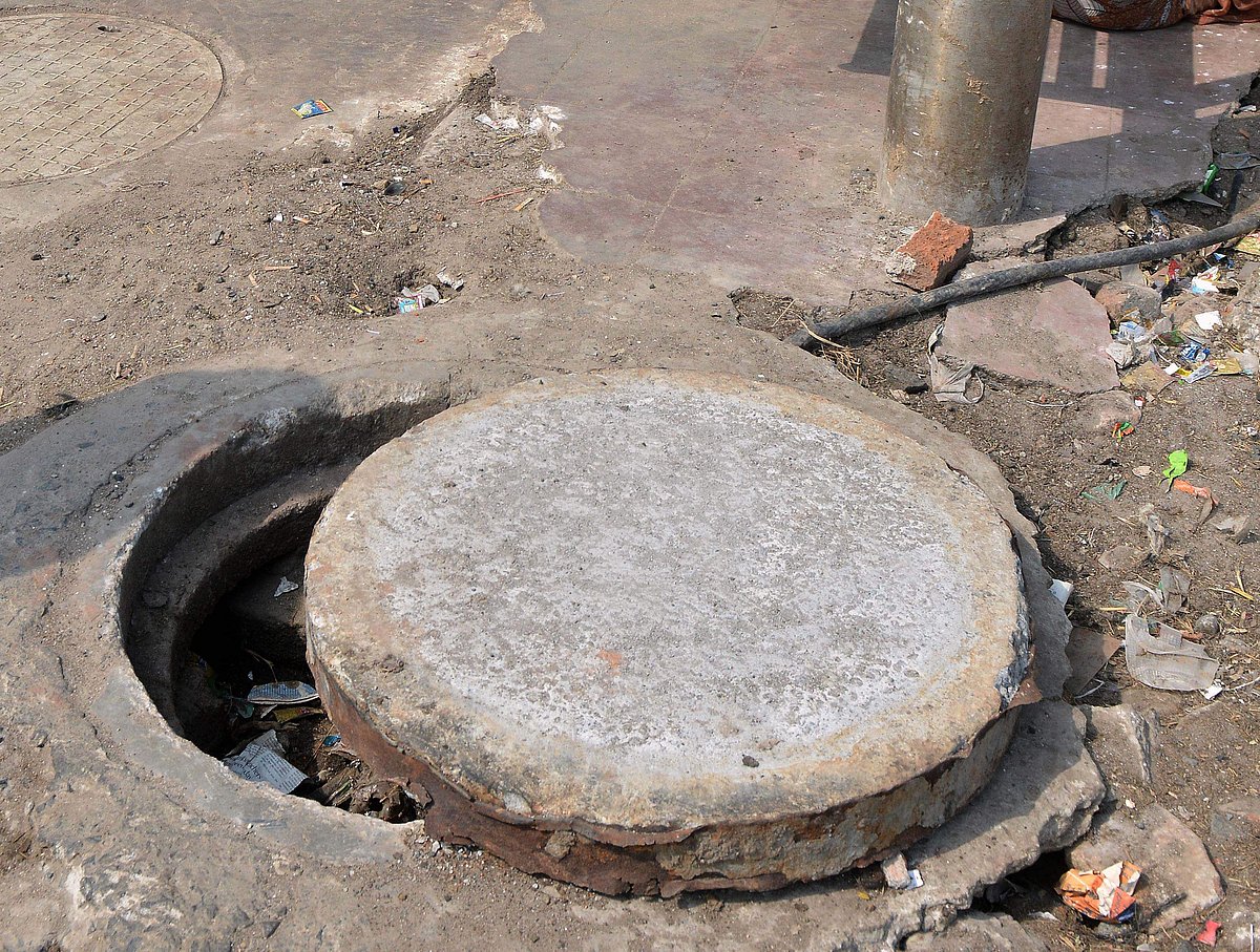 Woman injured after falling into manhole