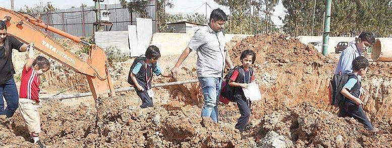 Students face daily risk as road outside school becomes muddy mess