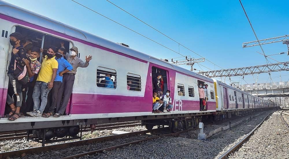 Social distancing? COVID-19 norms go for a toss as commuters cram local ...