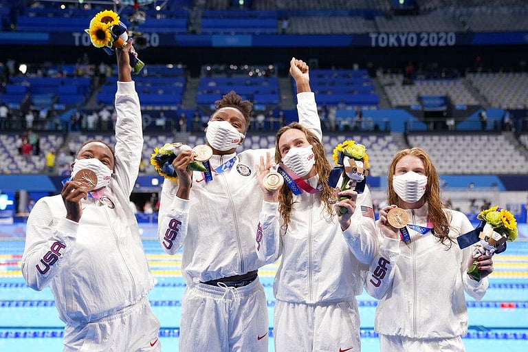 Powerhouse US swimming team shines with six medals, first gold for ...