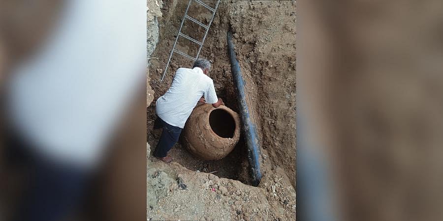 Ancient burial urn containing skeletal remains unearthed while digging ...