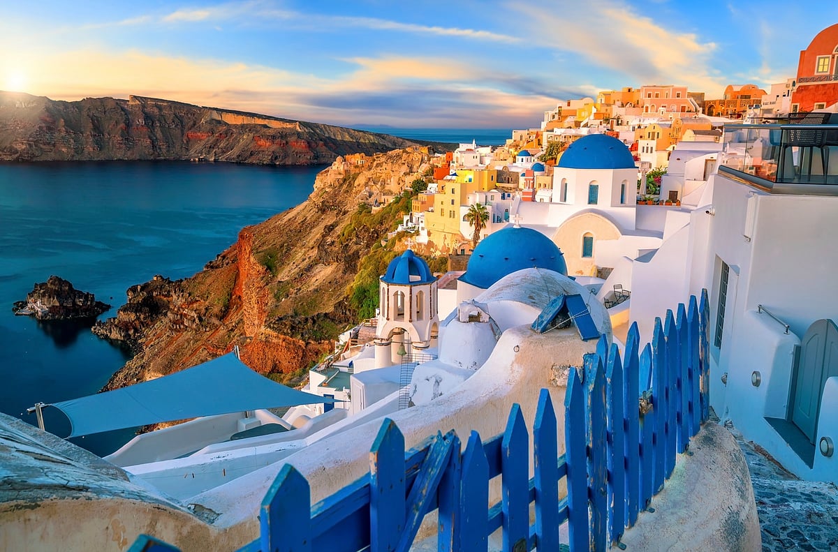 Why do people in Santorini paint houses white and blue?