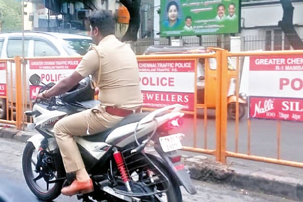 Sub-inspector caught riding bike without helmet, suspended