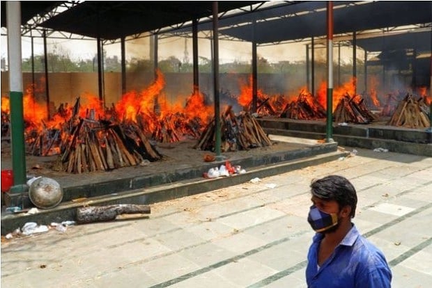 As death toll spirals, corpses wait in 20-hour queues for last rites at ...