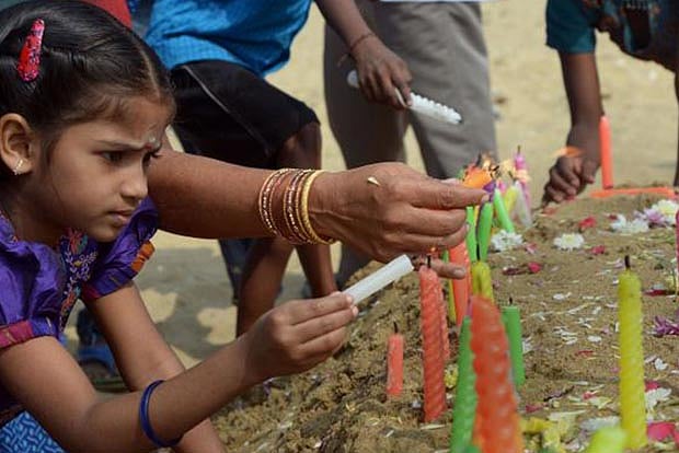Kin pay tributes to lost members on tsunami anniversary