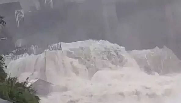 Overflowing water rolls over main dam of Lower Subansiri project