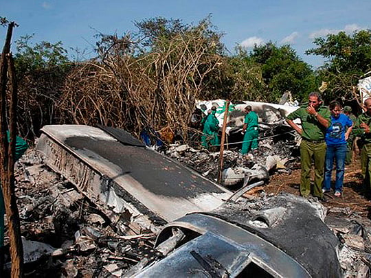 Rescue workers remove bodies from Cuba plane crash