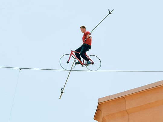 High-wire performer cycles over water at the Bahamas