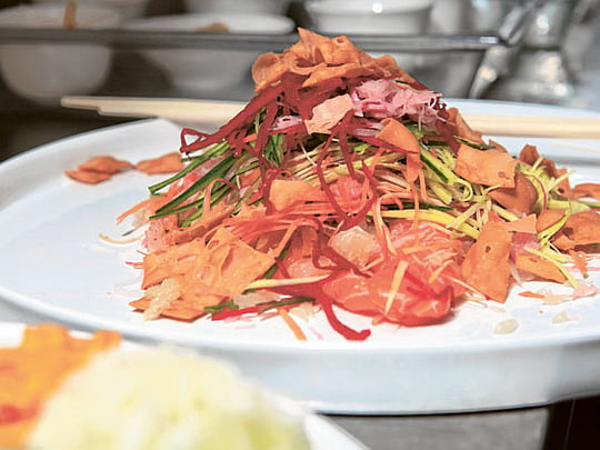 Yu Sheng, the Chinese New Year Salad tossed high in the air for good luck