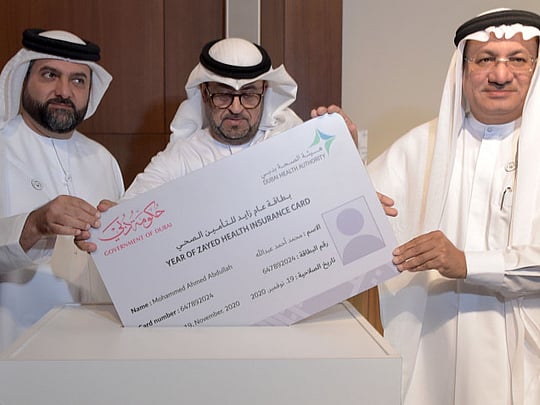 DHA unveils free insurance cards for 100 needy expatriates