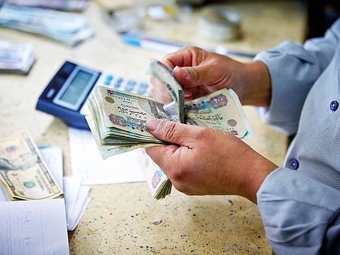 Egypt devalues currency to record low after jumbo rate hike