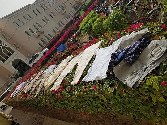 People drying laundry in public in Dubai’s International City