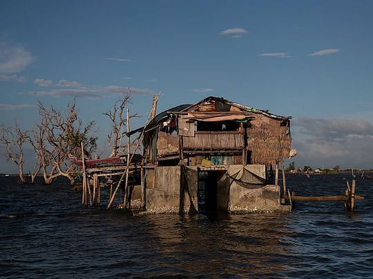 Rising seas threaten early end for sinking village in Philippines