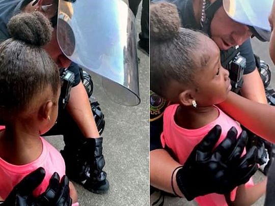 Viral video: US cop hugs tearful five-year-old protester after she asks ...