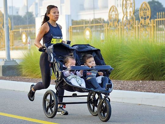 Watch: Canadian mum in UAE runs 42.2km marathon pushing 2 children in ...
