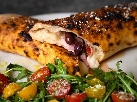 Make authentic Italian calzone or folded pizza