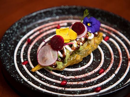 Crispy Palak Patta Chaat or spinach fritters with sweet yoghurt