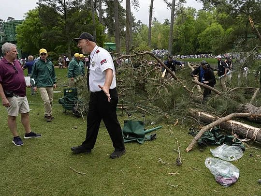Storms bring down pine trees at Masters, play suspended