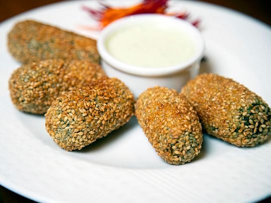 Till Palak Rolls or spinach rolls coated in sesame seeds