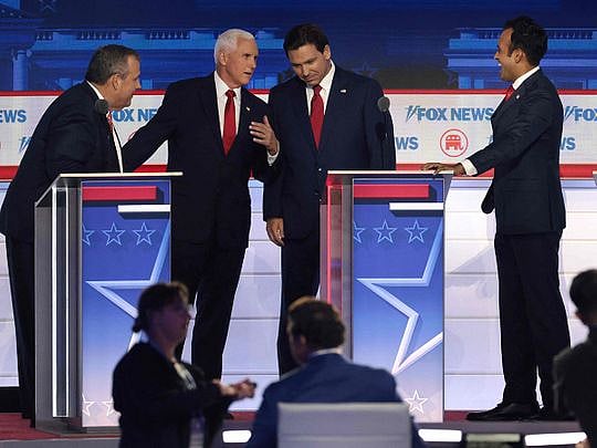Absent Trump steals show at raucous Republican debate