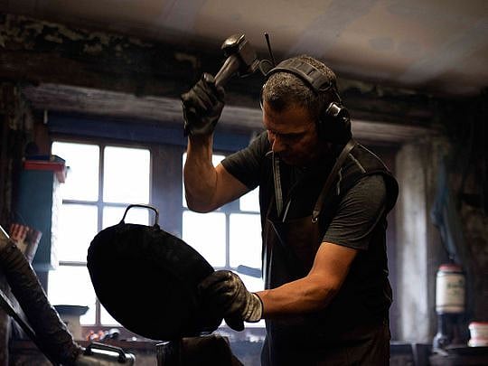 Photos: Bavarian hammersmith forges wrought-iron pans at a mill more ...