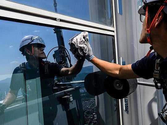 Photos: South Korea's skyscraper window cleaner with a fear of heights