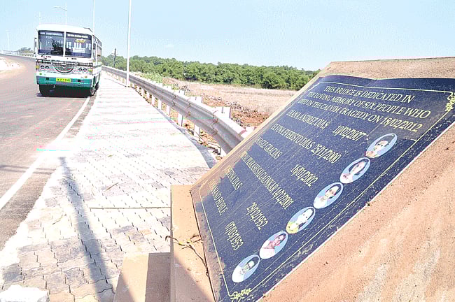 LEST WE FORGET: A bus passes by a memorial plaque built by the ...
