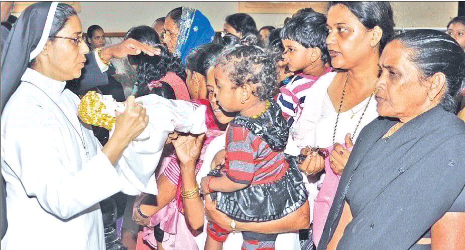 Devotees assemble to kiss the statue of Menino Jesus at Our Lady of ...