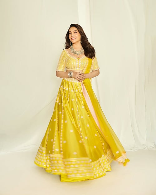 Madhuri Dixit dazzles in an embroidered yellow lehenga for Basant Panchami