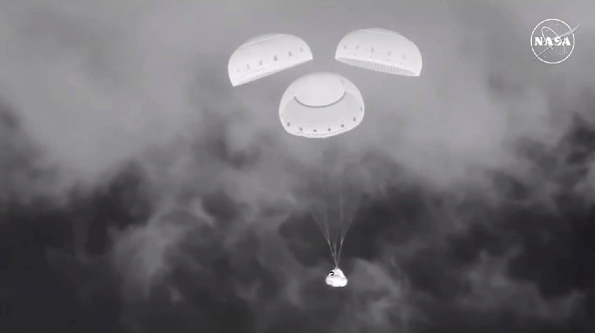 Boeing's troubled capsule returns to Earth empty, 2 astronauts left ...