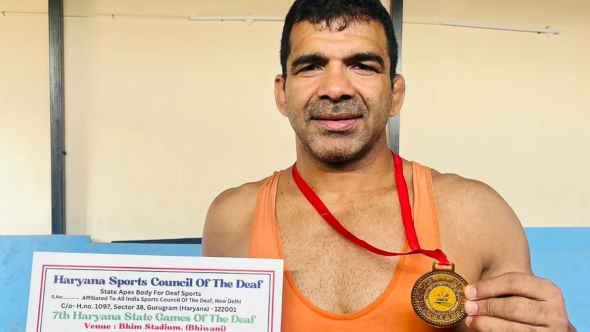 Deaflympics gold medallist wrestler Virender Singh Yadav next to give ...