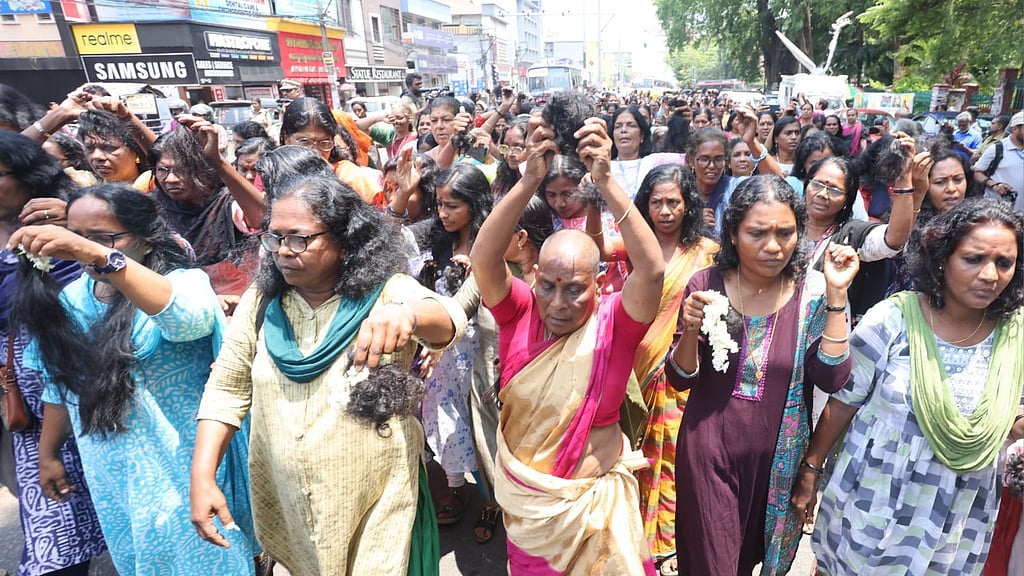 ASHA workers cut hair to mark 50th day of protest against Kerala government