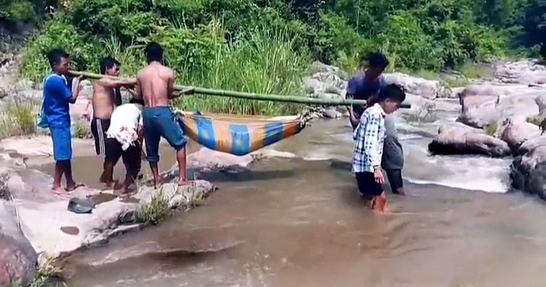Villagers carry patients through jungle for treatment