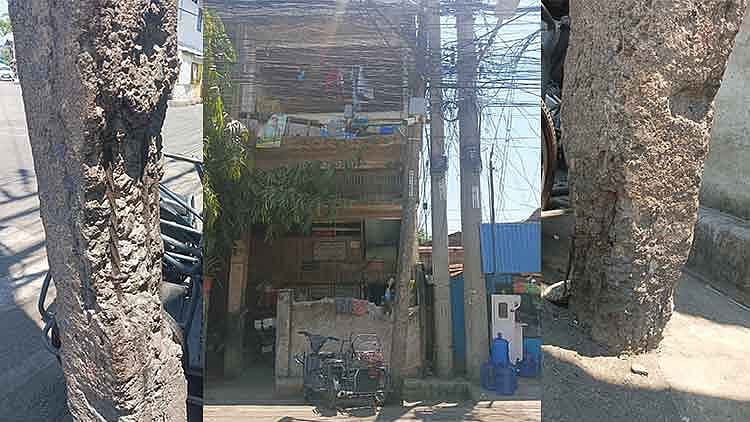 Leaning, chipped old concrete post