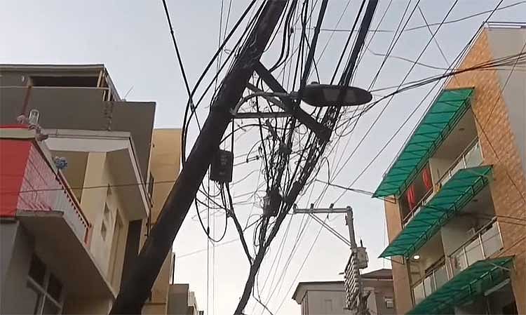 Leaning post with dangling wires