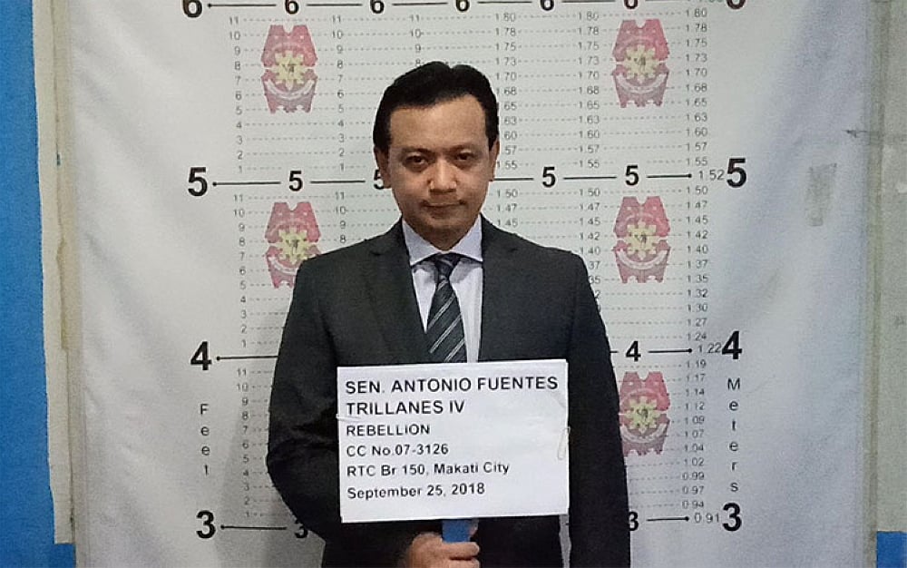 Senator Antonio Trillanes IV undergoes booking procedure