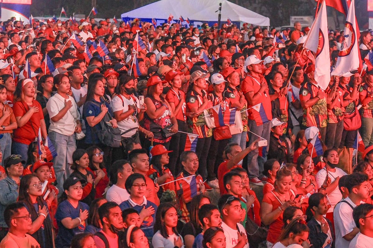 The crowd sings the national anthem at the kickoff rally