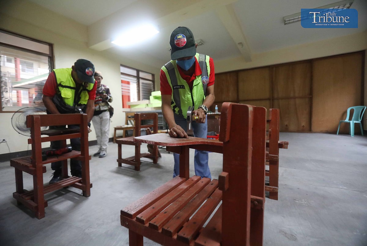 MMDA WORKERS REPAIR SCHOOL CHAIRS