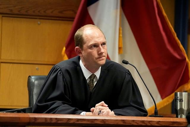 Judge dismisses three counts in Trump election case