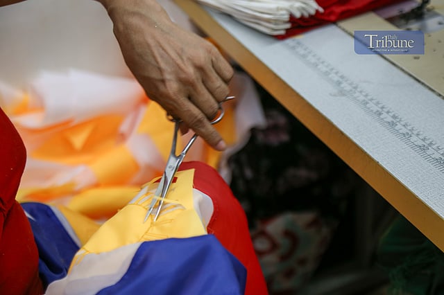 Seamstresses finish Phl flags in Manila