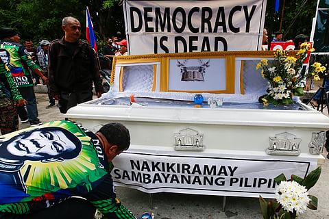 Protesters set up a coffin to symbolize the 'death of democracy'