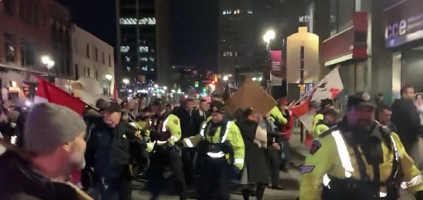 WATCH: Dozens of angry protestors swarm Trudeau in Hamilton